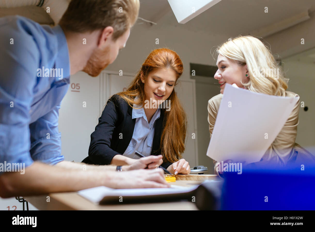 Team working on project together and sharing ideas in workshop Stock ...