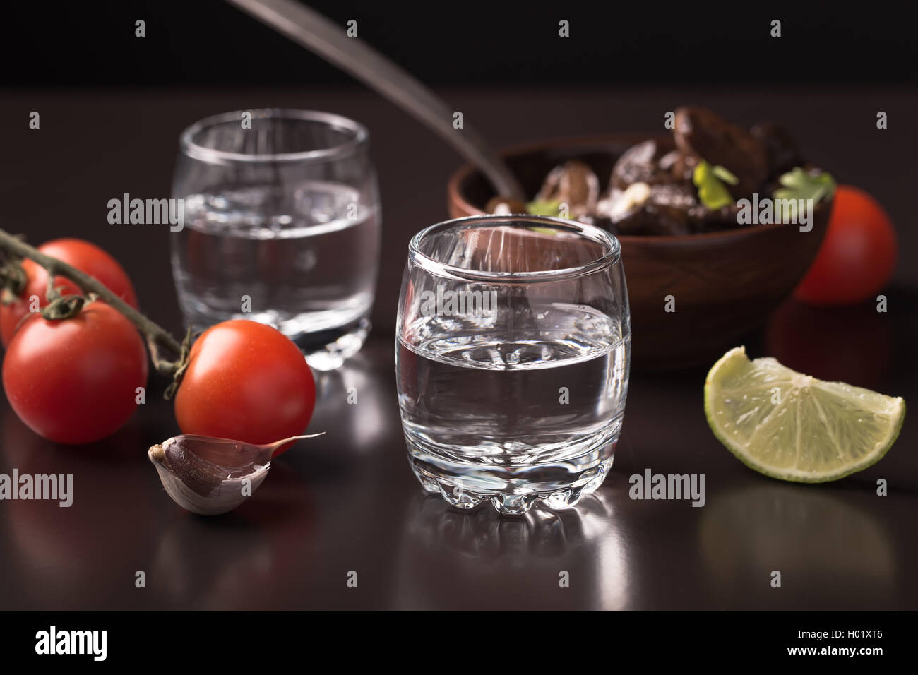 Two shot glass of vodka with mushrooms Stock Photo - Alamy