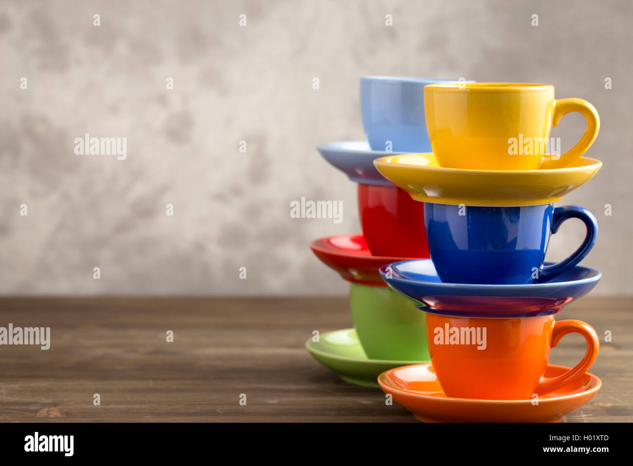 Two stacks multicolored cups on table from right side Stock Photo - Alamy