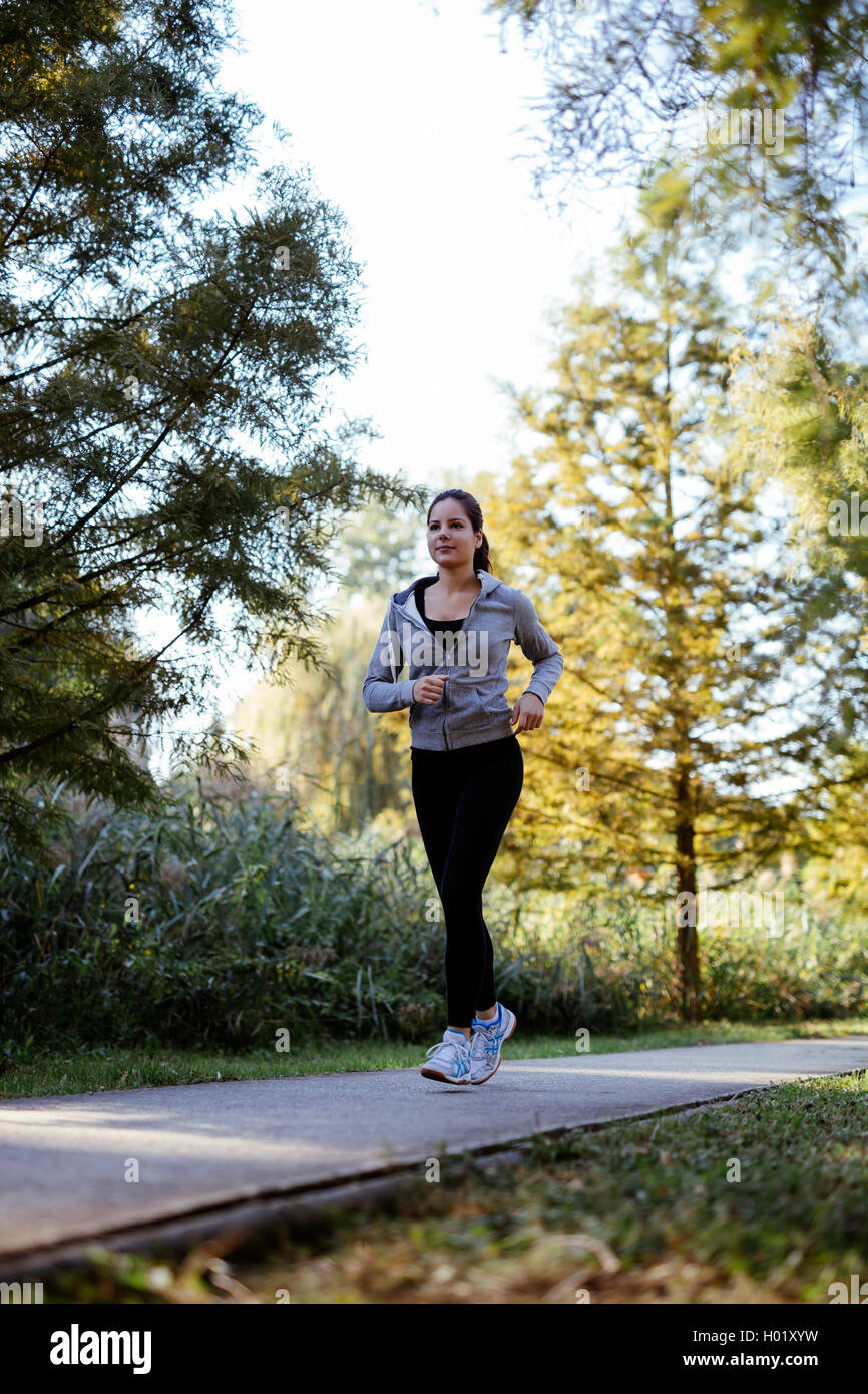 Fit beautiful woman jogging in park and staying healthy Stock Photo - Alamy