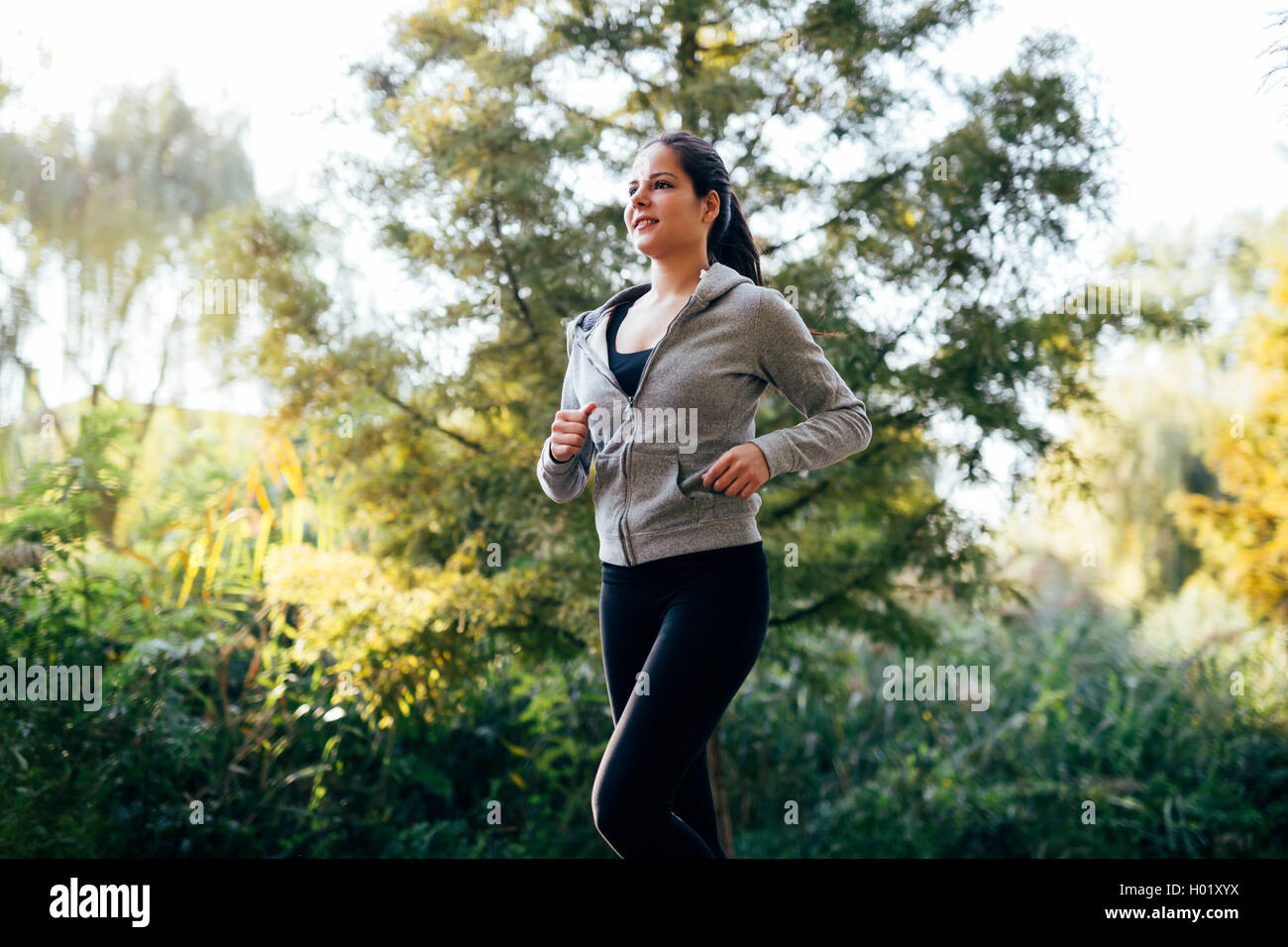 Fit beautiful woman jogging in park and staying healthy Stock Photo - Alamy