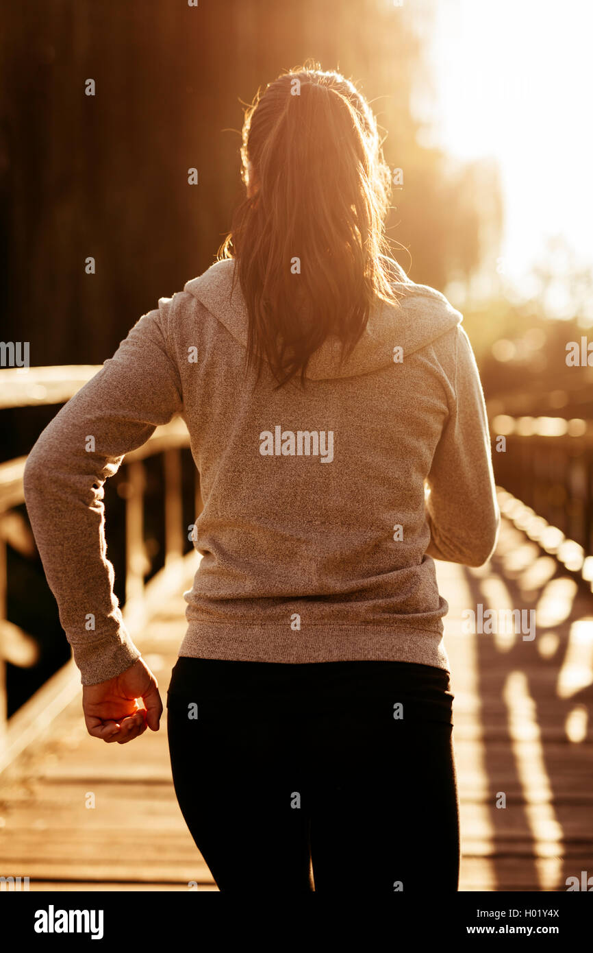 Beautiful female runner jogging in nature Stock Photo - Alamy