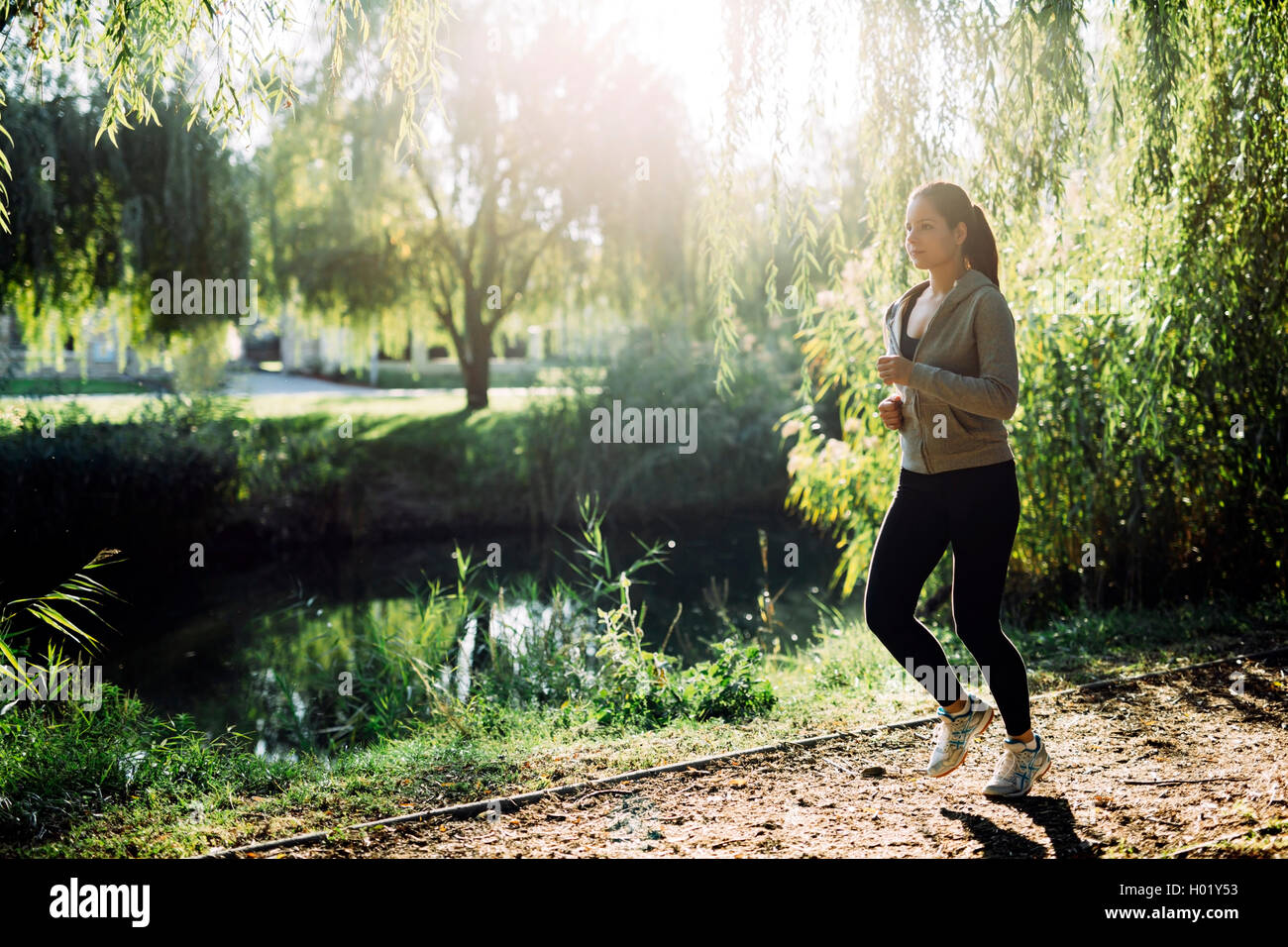 Fit woman jogging outdoors in nature Stock Photo - Alamy