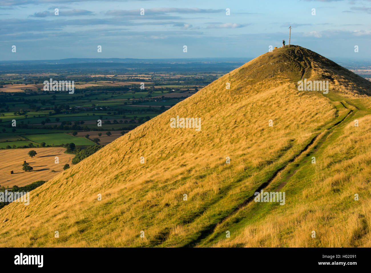 Walkers and their dogs on the summit of the Lawley, Shropshire, England ...