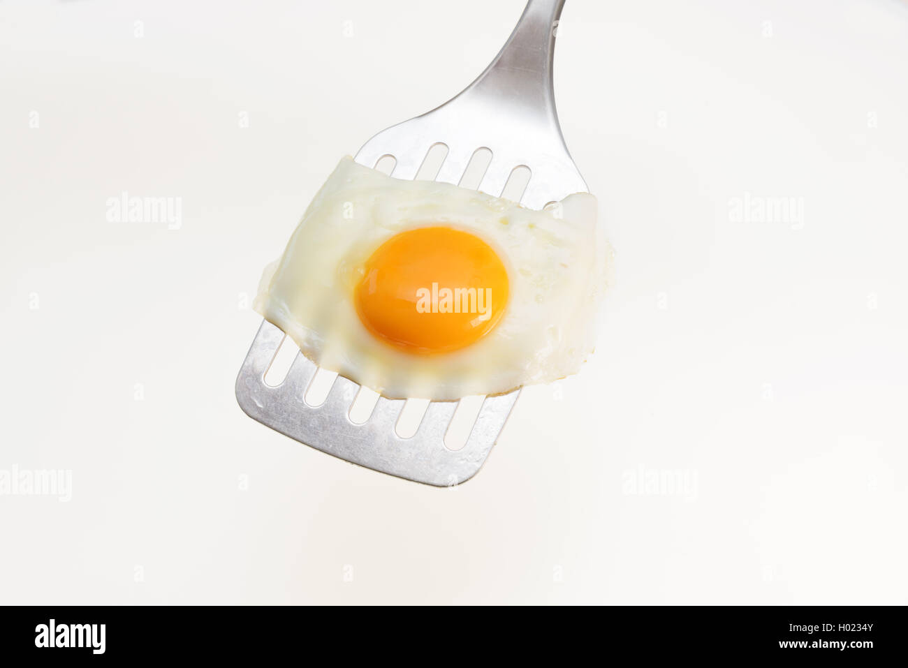 Appetizing and Perfectly Fried Egg on a Spatula, isolated on white ...