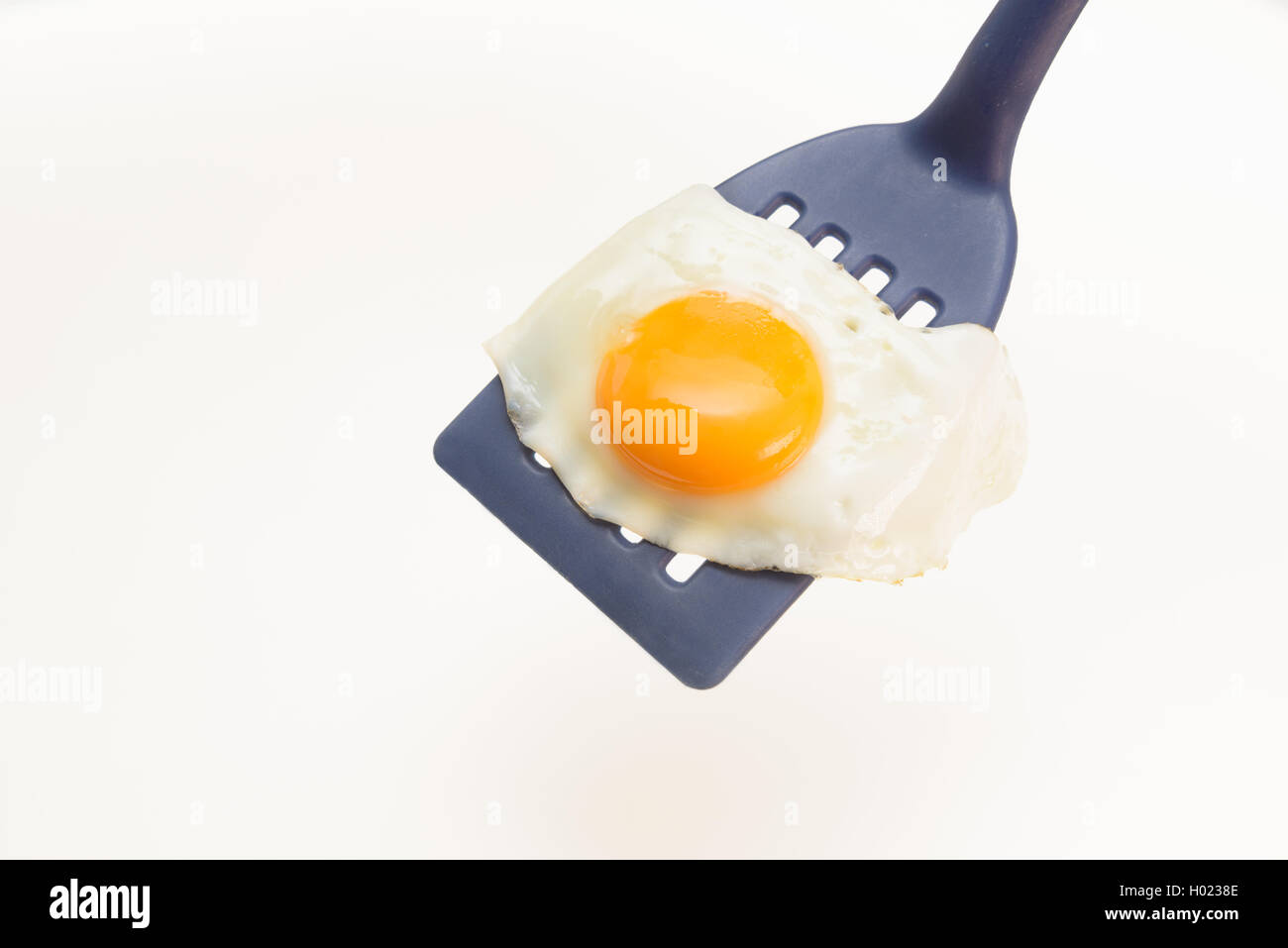 Appetizing and Perfectly Fried Egg on a Spatula, isolated on white ...
