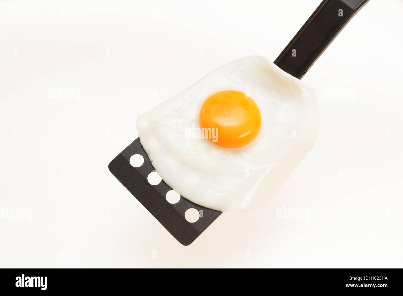 Appetizing and Perfectly Fried Egg on a Spatula, isolated on white ...