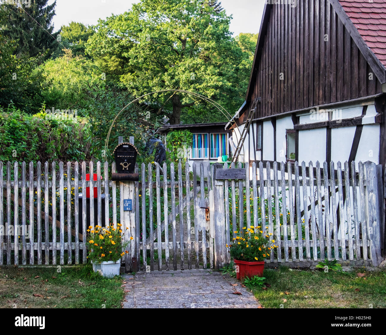 Quaint cottage with rustic fence at Stechlin Lake holiday resort and ...