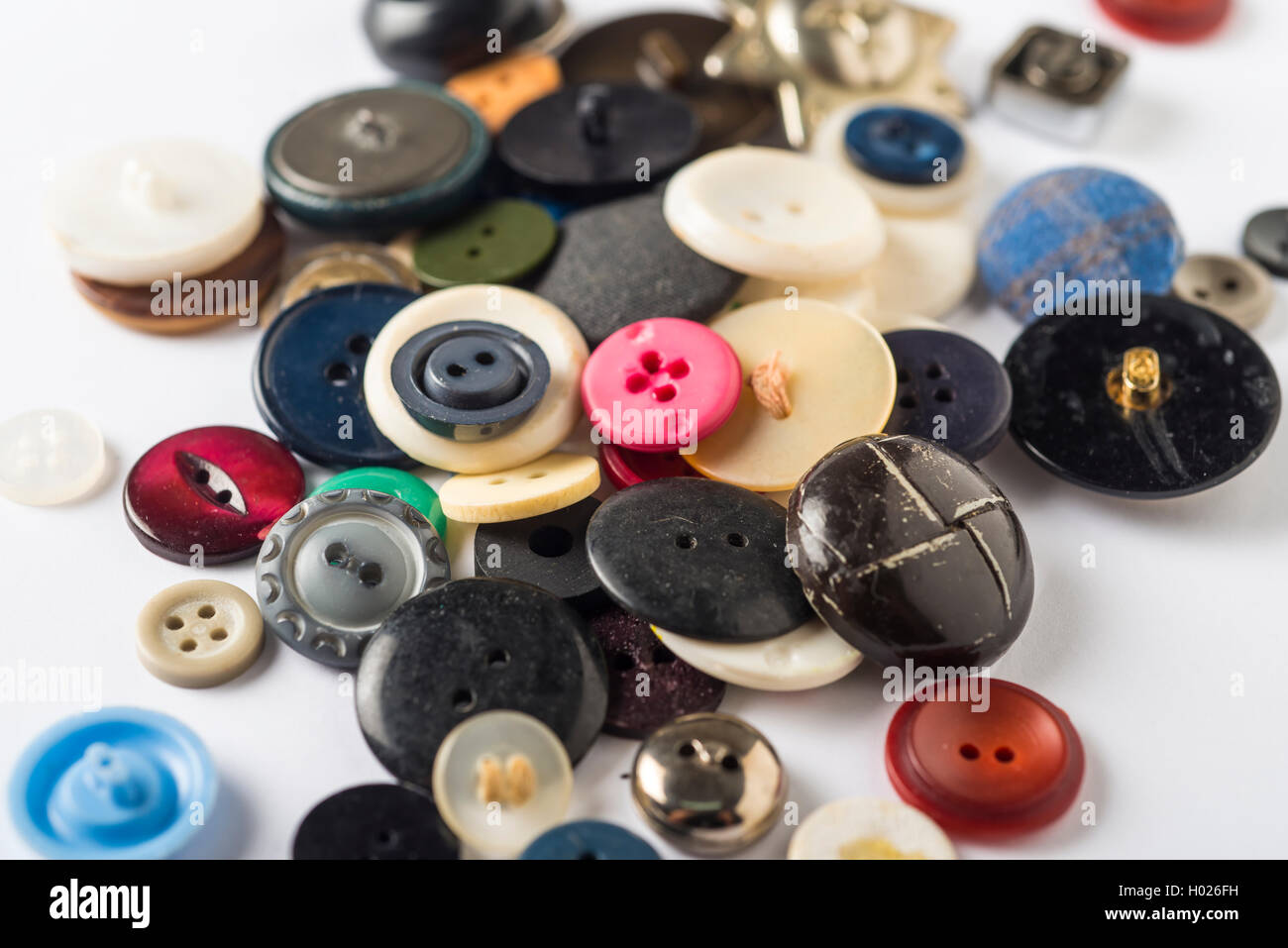 Sewing plastic buttons Stock Photo - Alamy