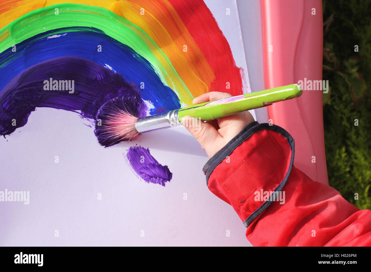 School child painting rainbow on easel Stock Photo - Alamy