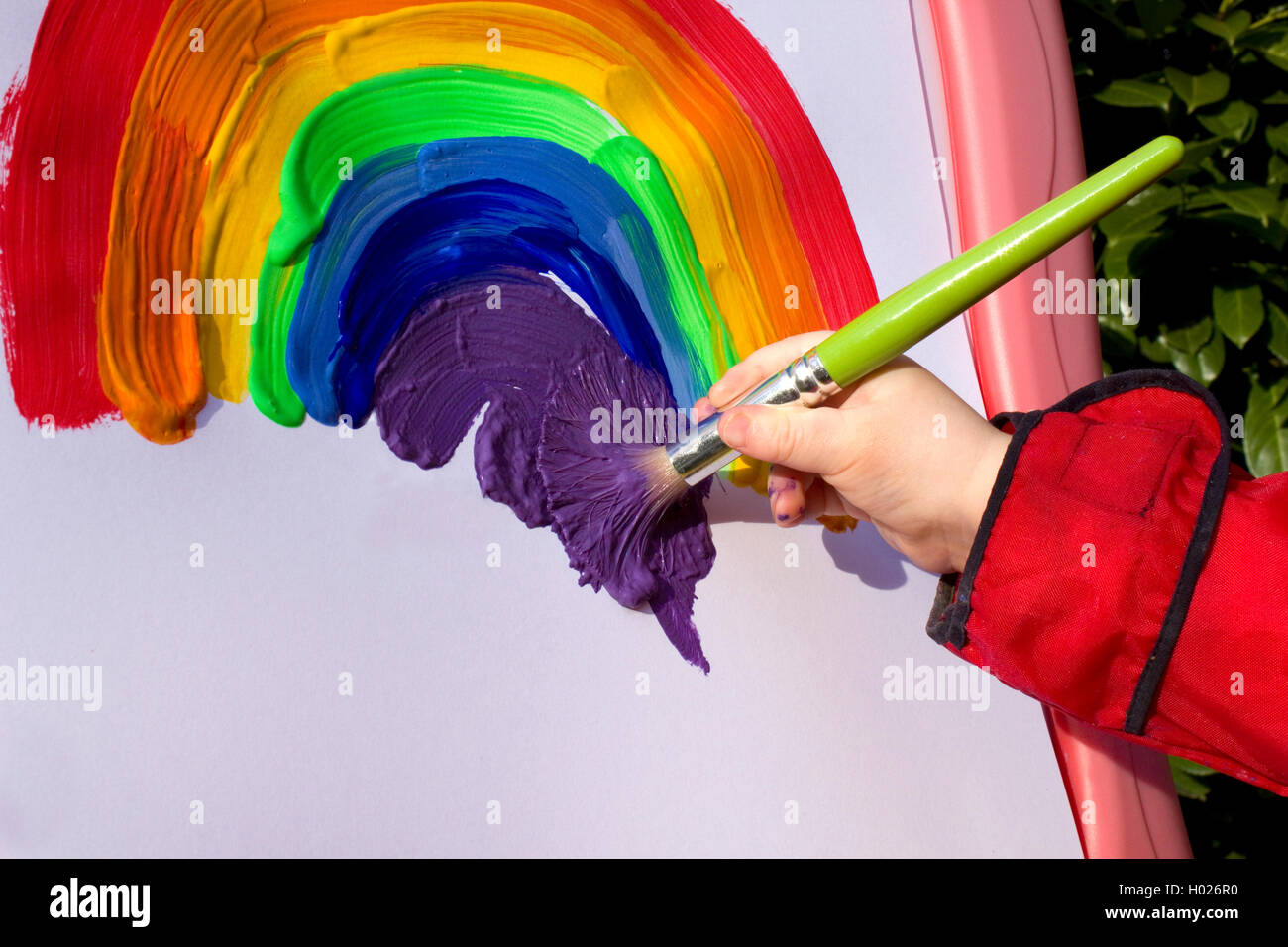 School child painting rainbow on easel Stock Photo - Alamy