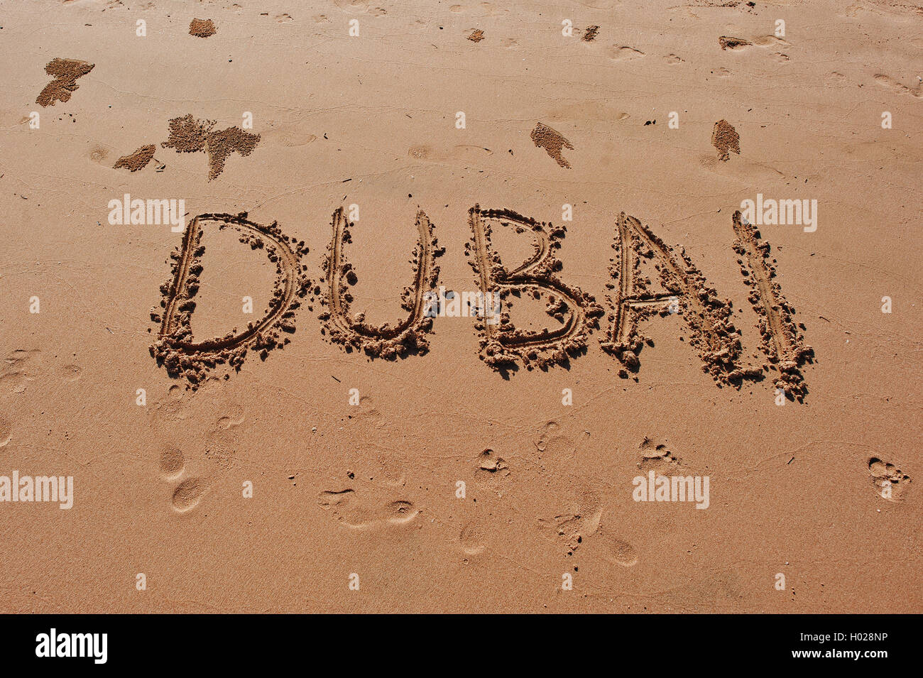 "Dubai" written in the sand on the beach Stock Photo - Alamy
