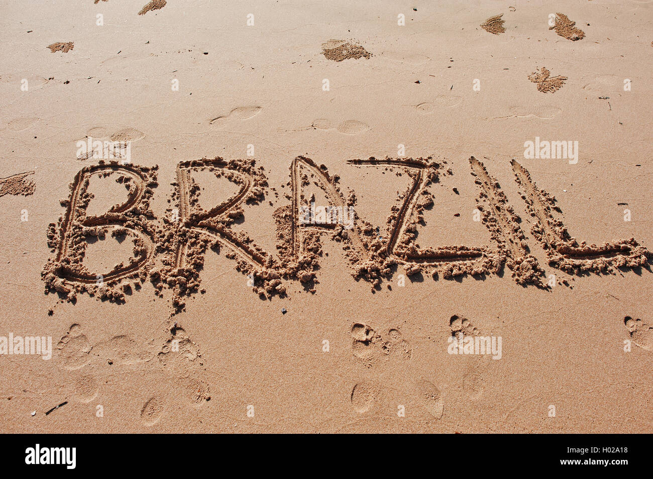 "Brazil" written in the sand on the beach Stock Photo - Alamy