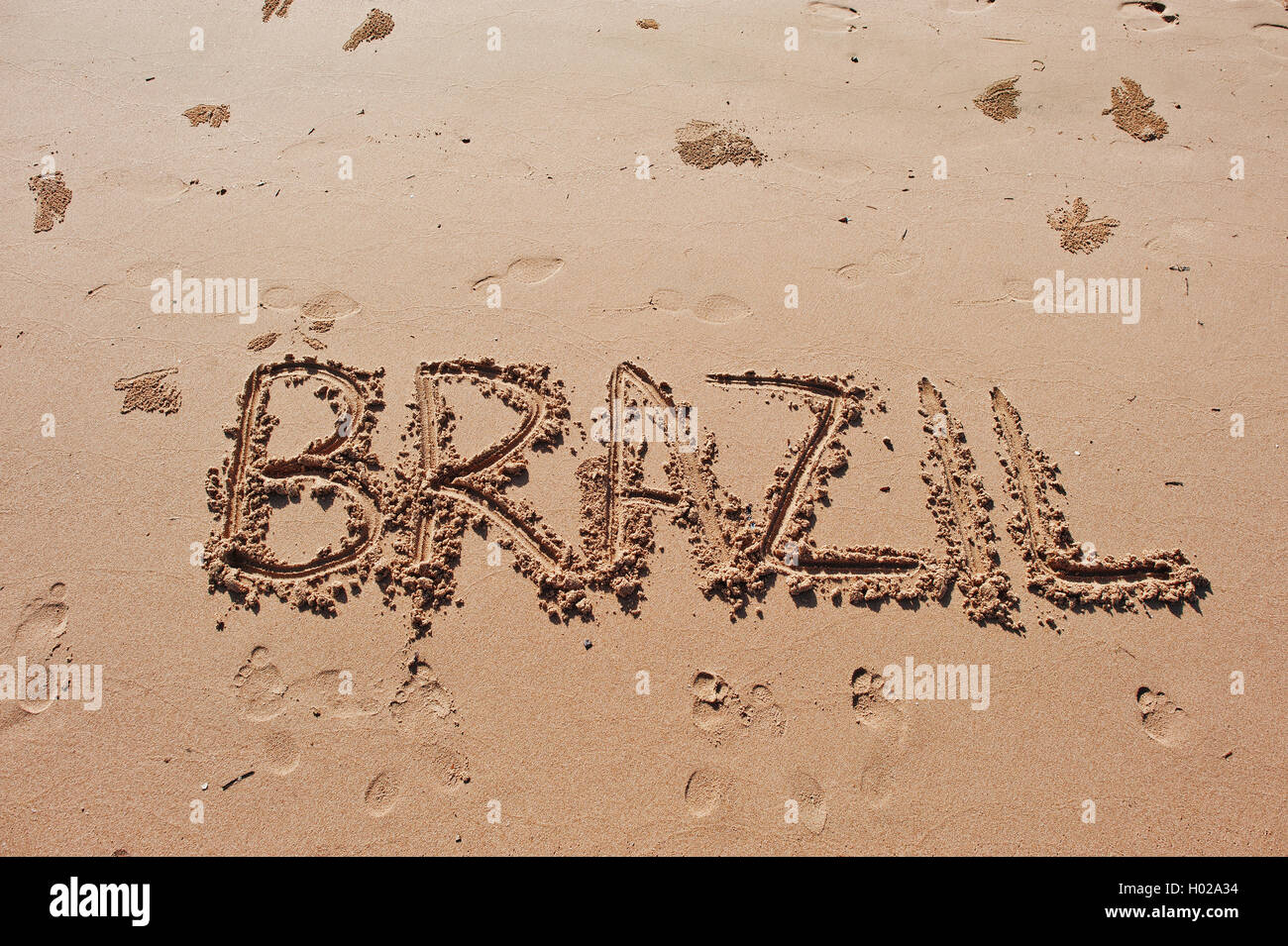"Brazil" written in the sand on the beach Stock Photo - Alamy