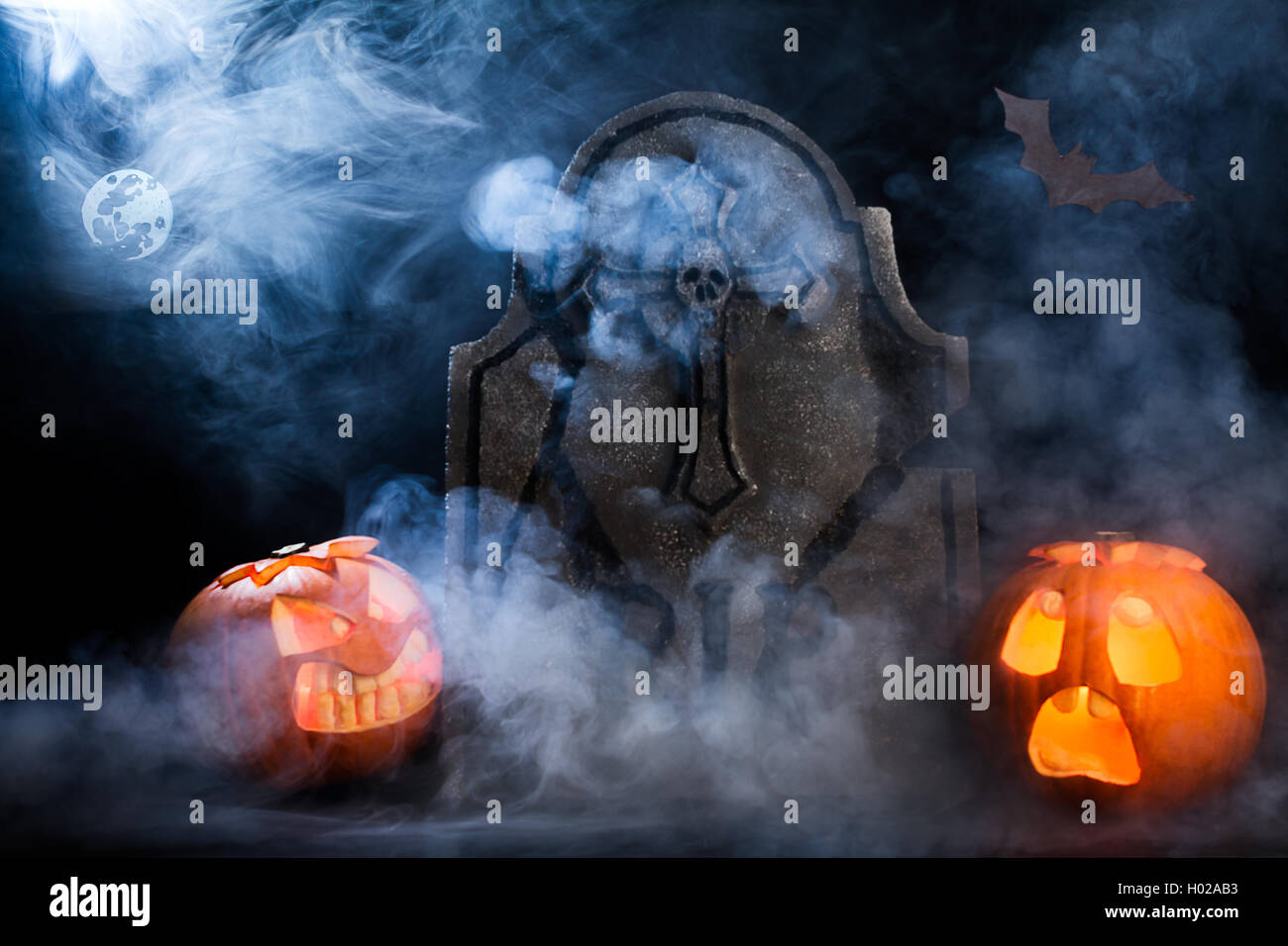 Angry face and scared face of Halloween pumpkins with moon, tombstone ...