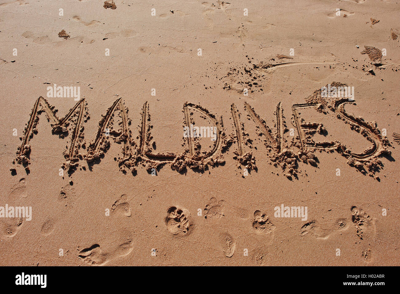 "Maldives" written in the sand on the beach Stock Photo - Alamy