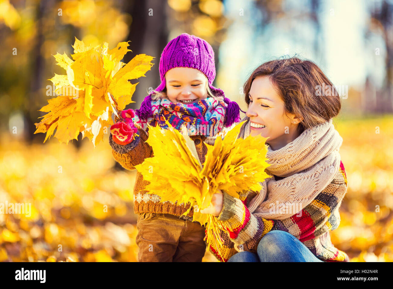 Mother and daughter playing in autumn park Stock Photo - Alamy