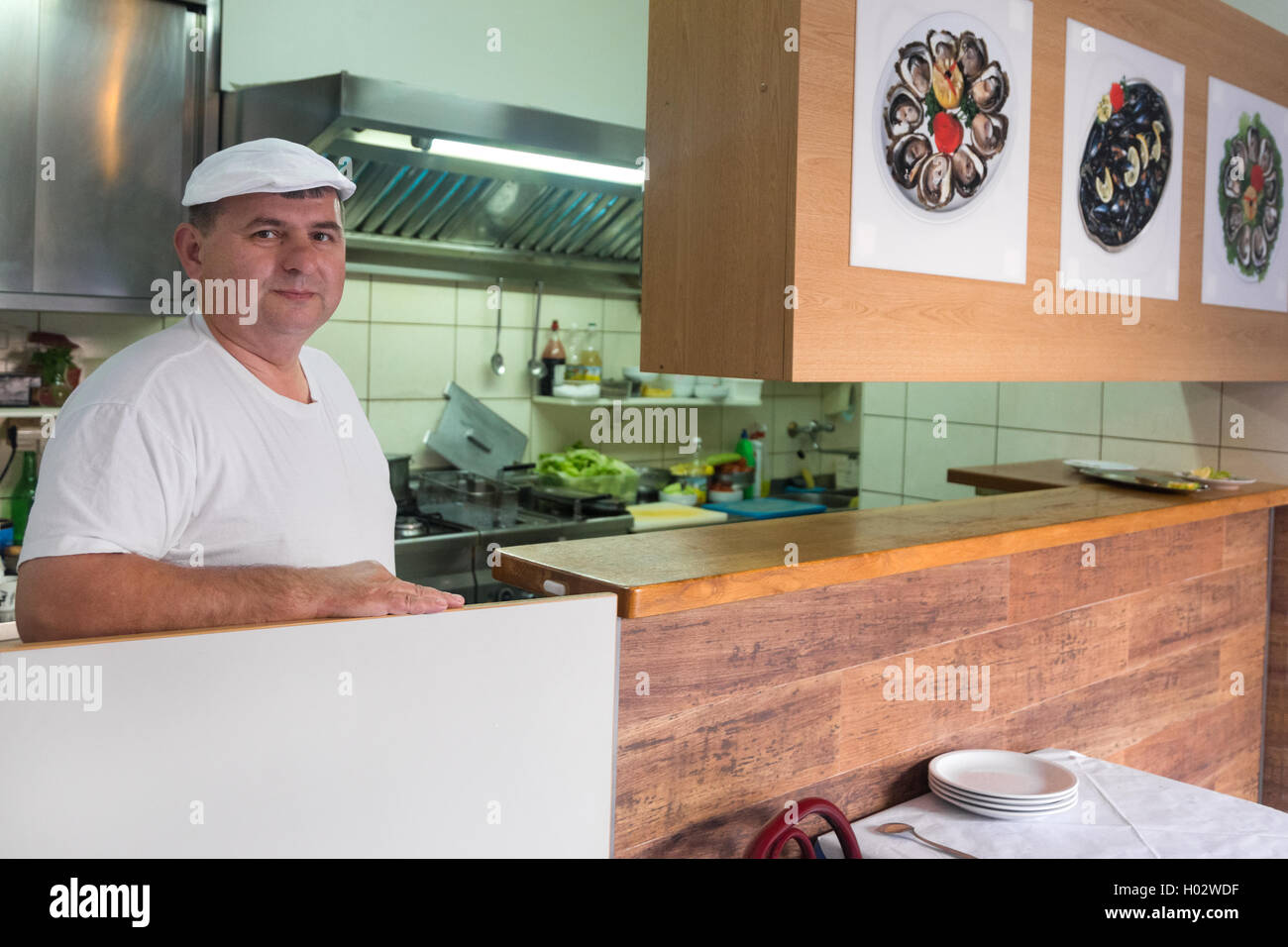 Man standing behind table hi-res stock photography and images - Alamy