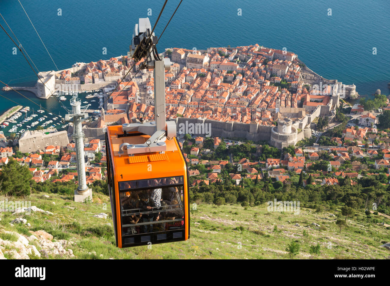DUBROVNIK, CROATIA - MAY 26, 2014: Tourists at Cable car which connects ...