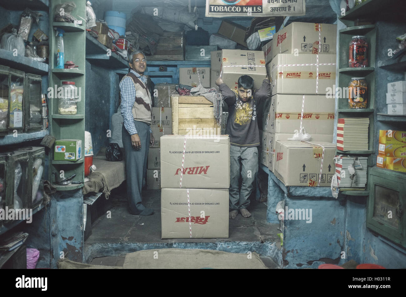JODHPUR, INDIA - 07 FEBRUARY 2015: Shop owner and young worker in ...