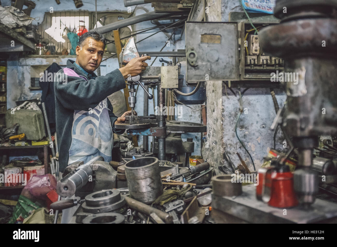 JODHPUR, INDIA - 07 FEBRUARY 2015: Indian mechanic works in workshop ...