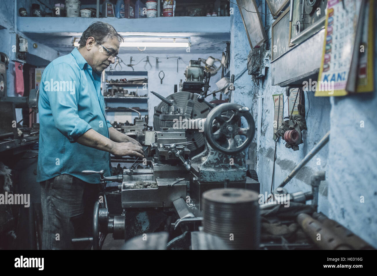 JODHPUR, INDIA - 17 FEBRUARY 2015: Mechanic working late in workshop ...