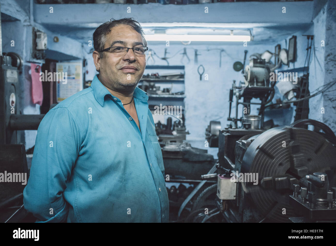JODHPUR, INDIA - 17 FEBRUARY 2015: Mechanic working late in workshop ...
