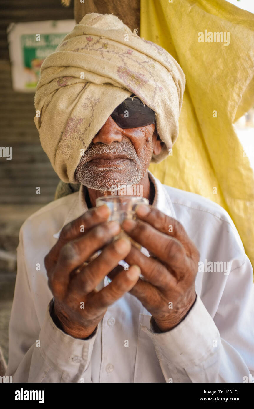 HAMPI, INDIA - 31 JANUARY 2015: Blind elderly Indian man with ...