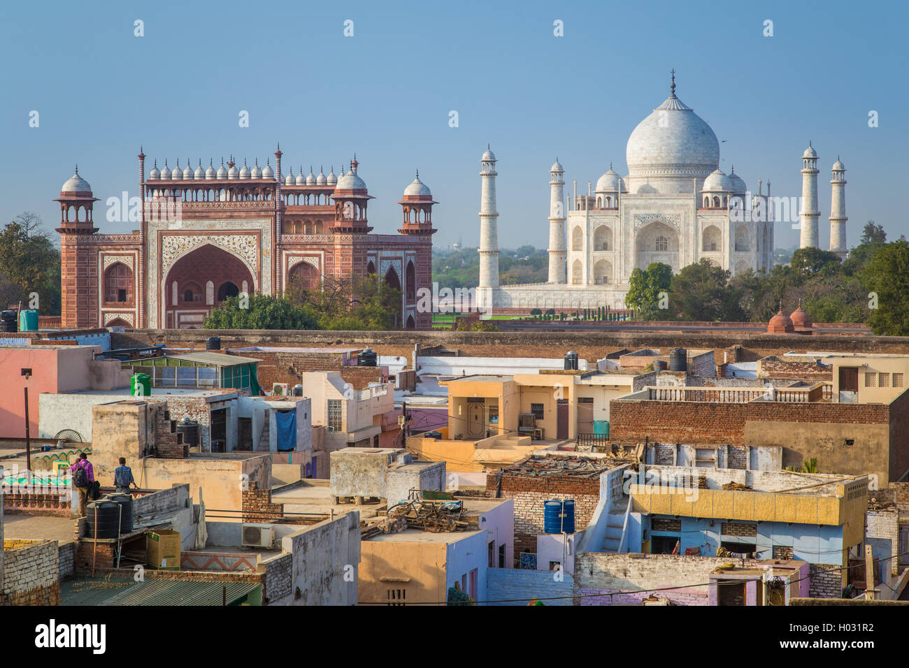 Taj Mahal, Great Gate and rooftops of neighbouring houses in foreground ...