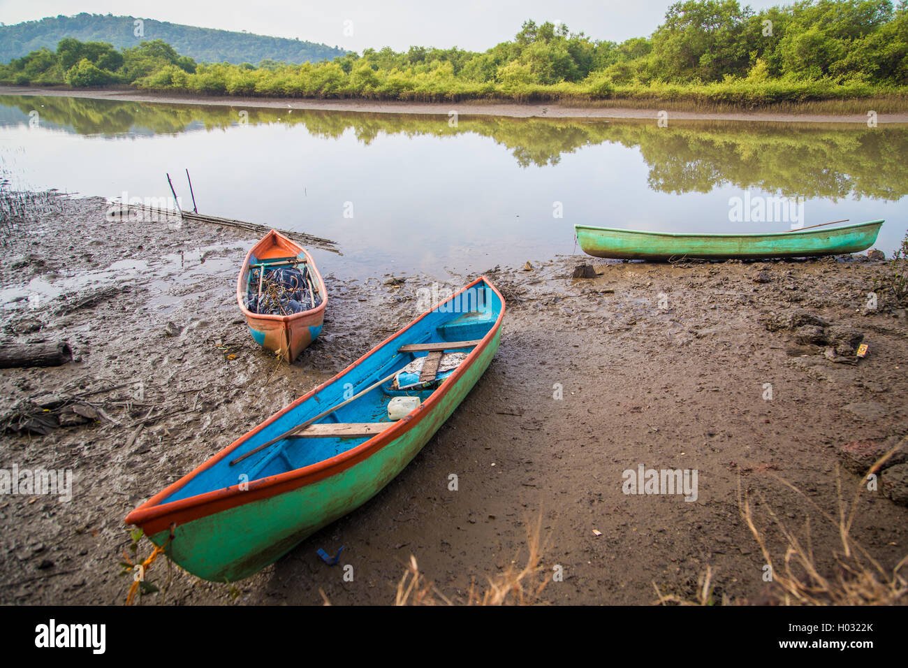 Three canoes on river bank in Goa, India Stock Photo - Alamy