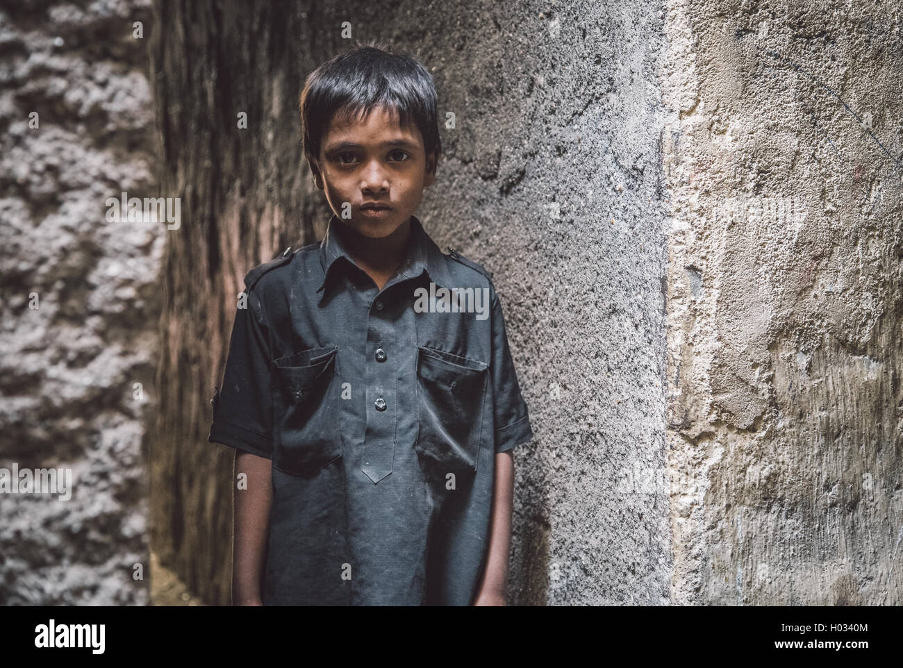 MUMBAI, INDIA - 12 JANUARY 2015: Young Indian boy from Dharavi slum ...