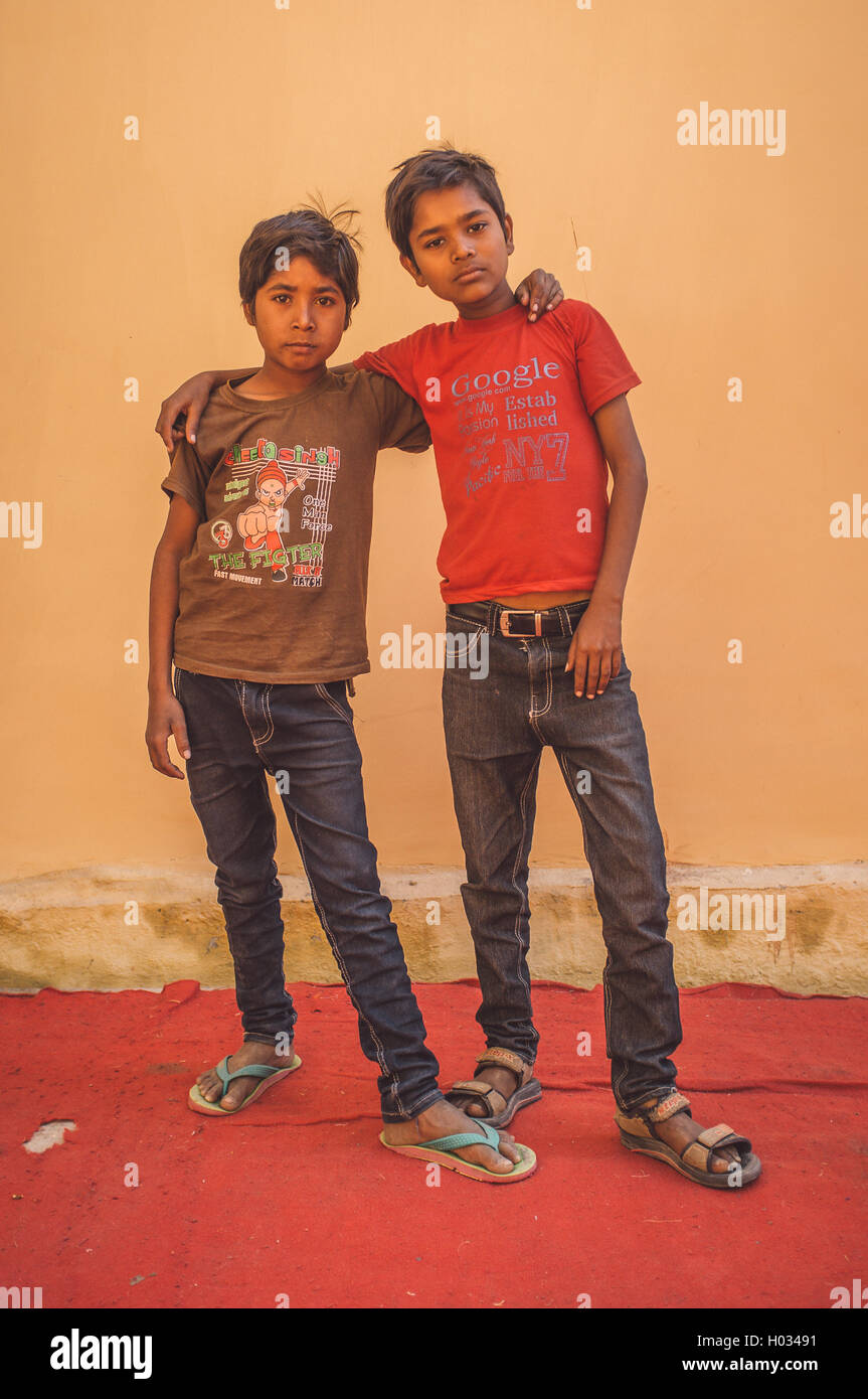GODWAR REGION, INDIA - 15 FEBRUARY 2015: Two Indian boys hug in front ...