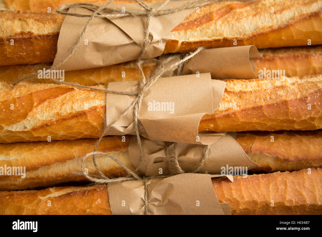 Loafs of French baguette bread tied together with paper and string ...