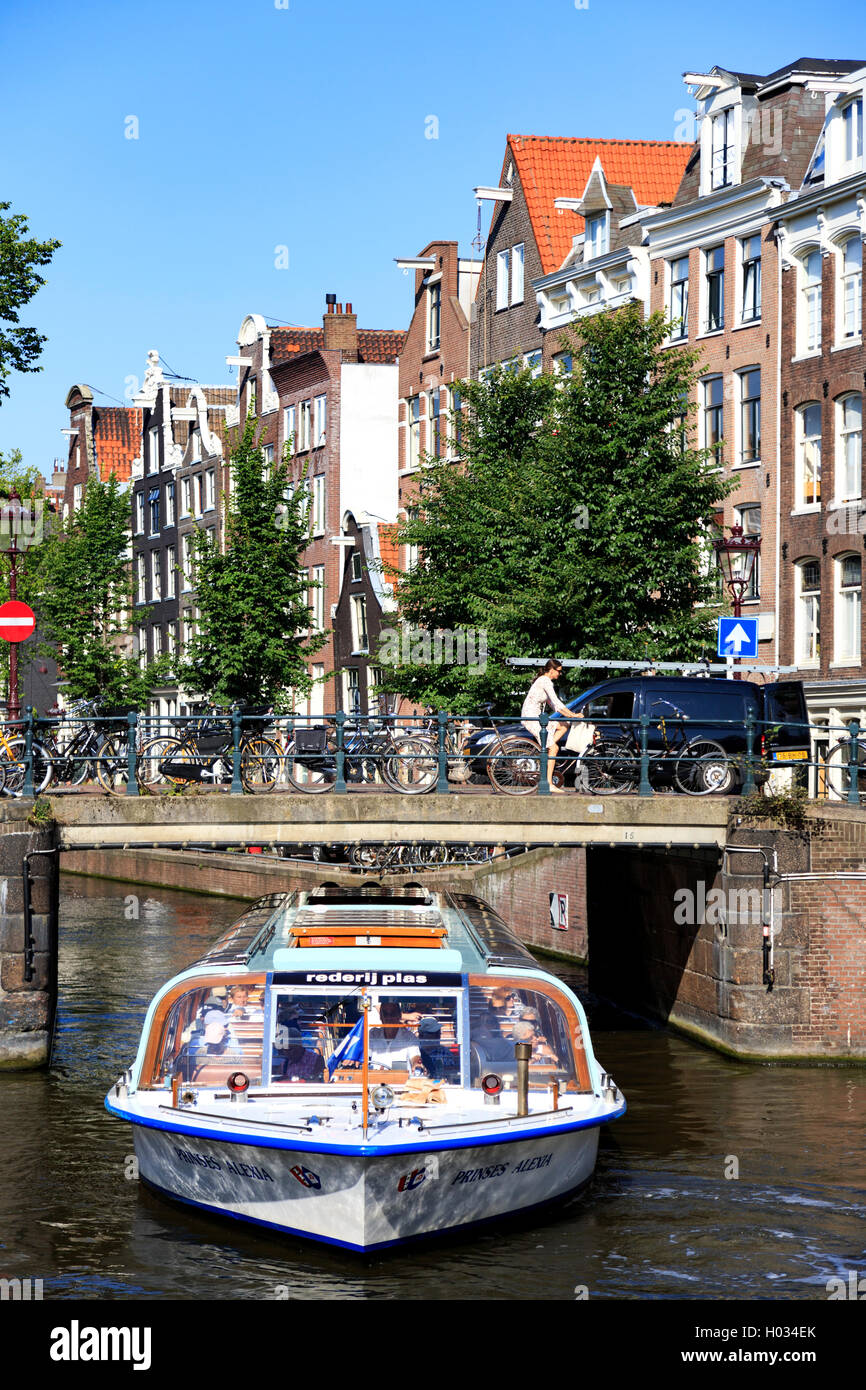 A tourist pleasure boat passing under one of the many bridges over the ...