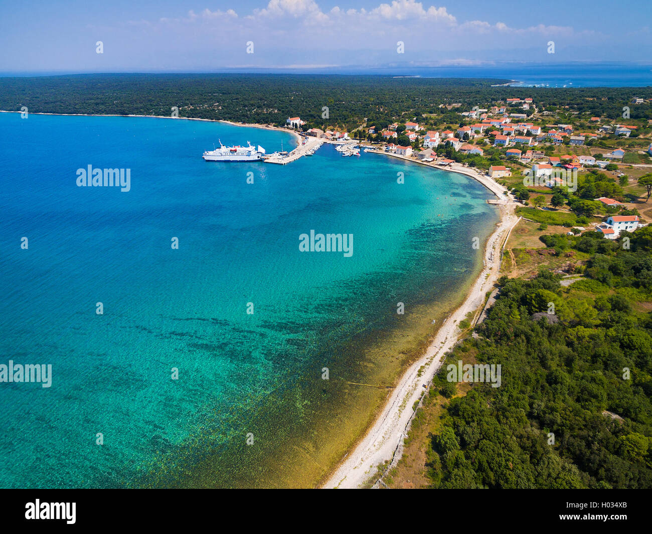 Aerial view of beach and ferry boat at Olib island harbour, Croatia ...