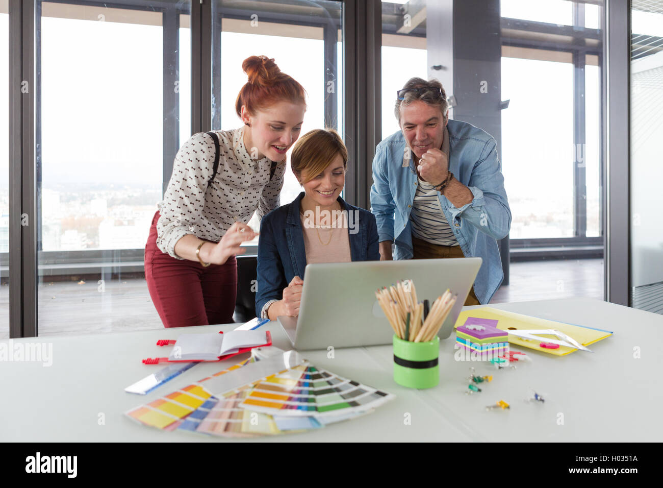 Business people in modern office celebrating good business results ...