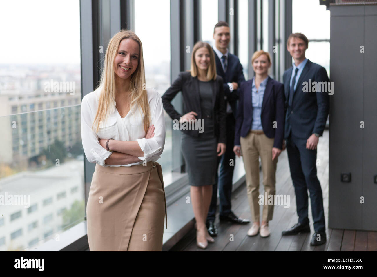 Corporate portrait of young business woman with her colleagues in ...