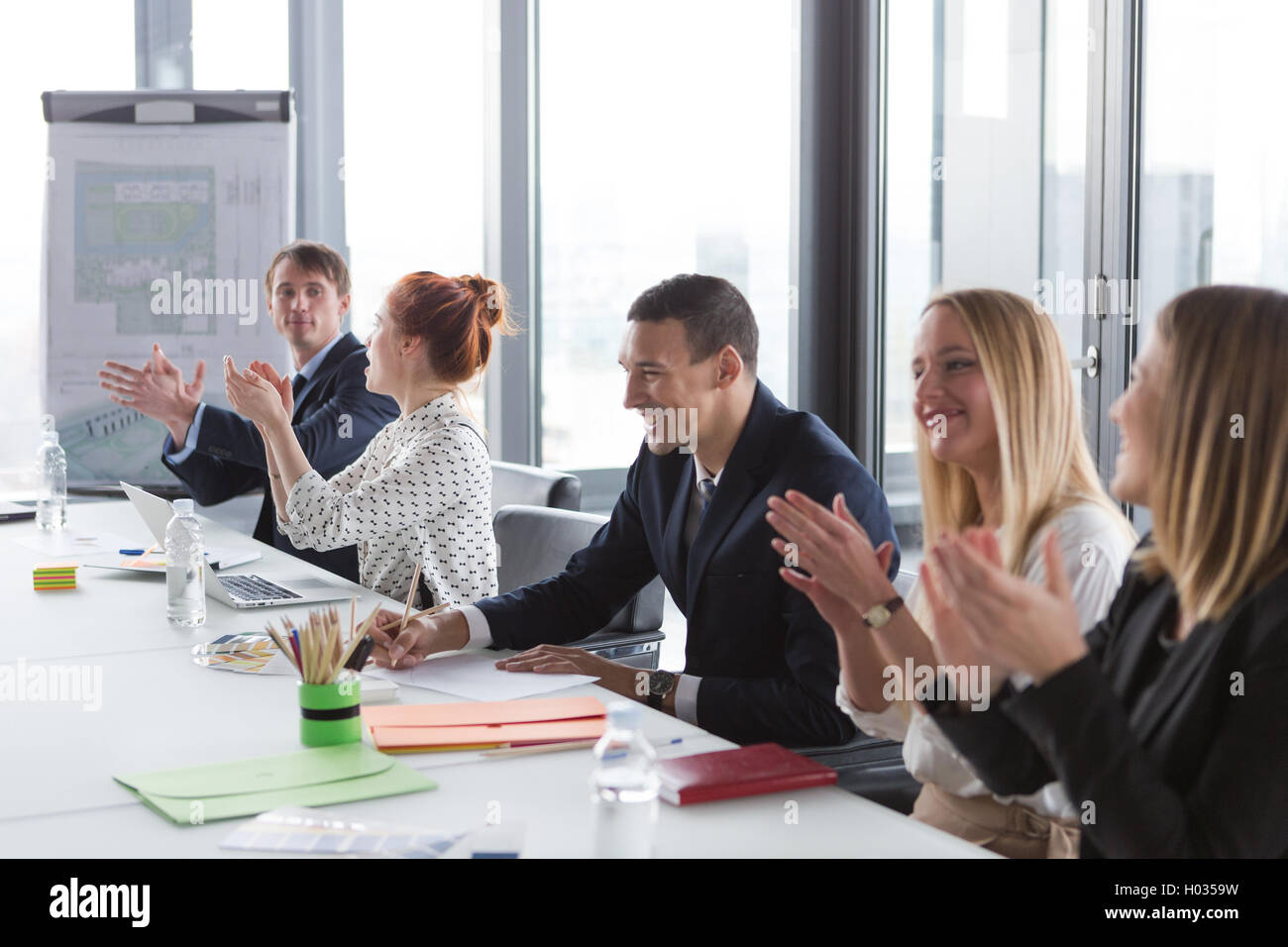 Business people clapping hands during the meeting in modern office ...