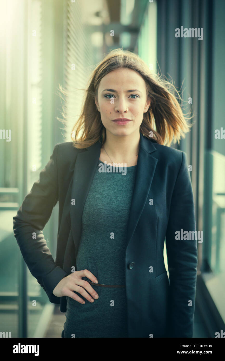 Portrait of young attractive business woman in the office. Post ...