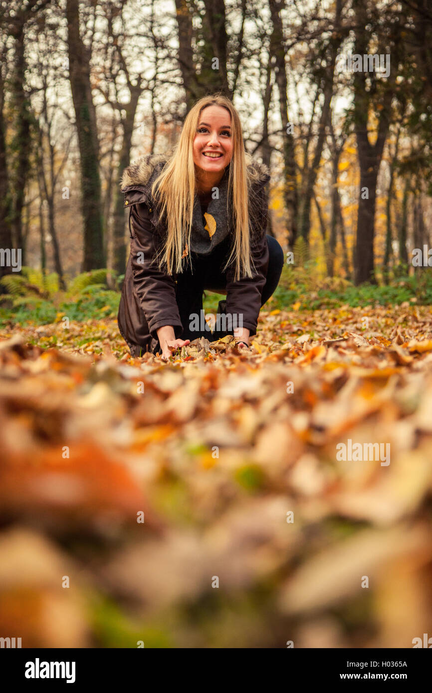 Young woman plays with leave sin park on an autumn day Stock Photo - Alamy