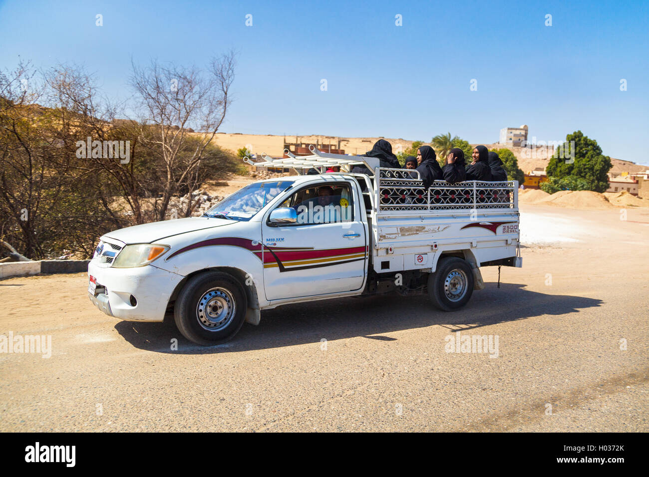 ASWAN, EGYPT - FEBRUARY 7, 2016: Man driving group of women with hijab ...