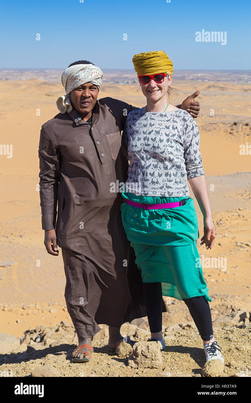 ASWAN, EGYPT - FEBRUARY 7, 2016: Nubian man wearing traditional clothing posing with european ...