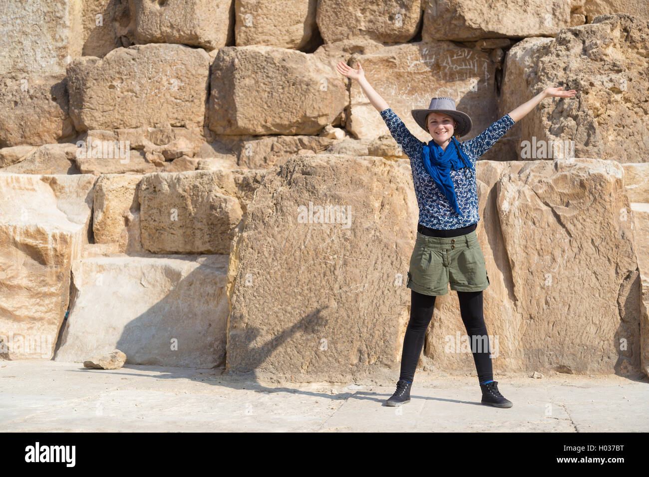 Tourist posing in front of The Great Pyramid of Giza, Egypt Stock Photo ...