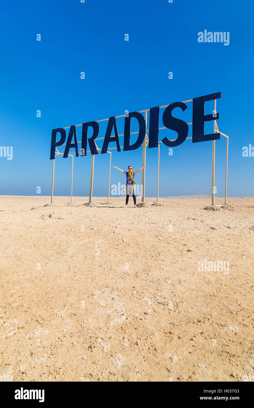 Tourist spreading arms under the Paradise sign Stock Photo - Alamy