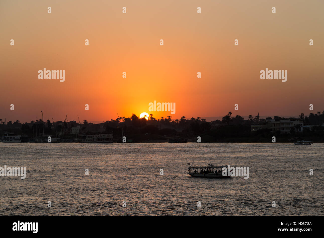 Tourist boat at Luxor waterfront during sunset Stock Photo - Alamy