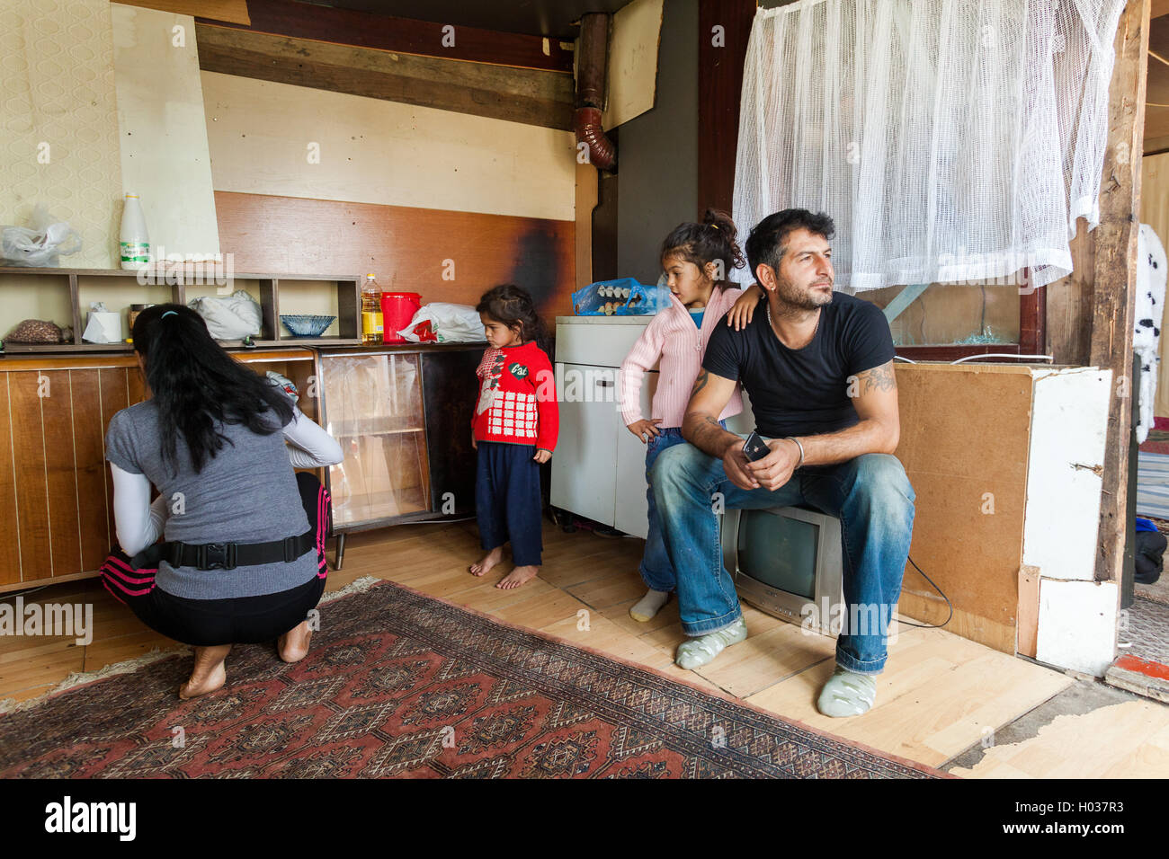 ZAGREB, CROATIA - OCTOBER 21, 2013: Roma man and his family at their ...