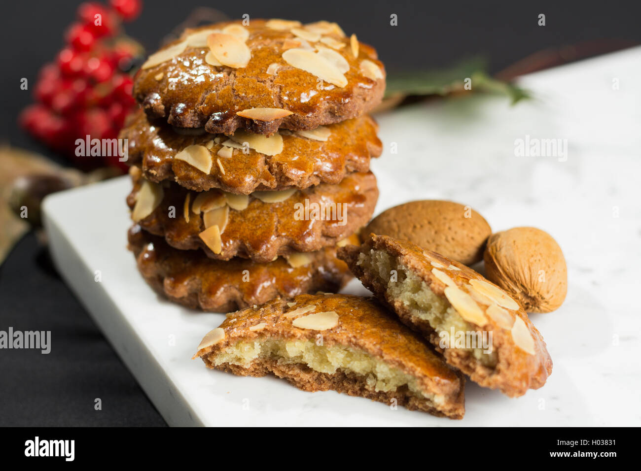 Dutch marzipan filled cookies with almonds on autumn colored and dark ...
