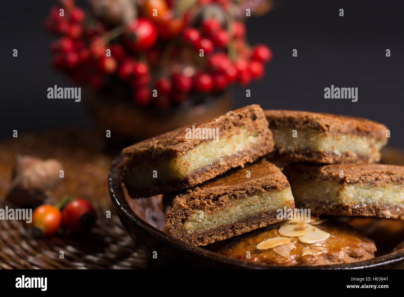 Dutch marzipan filled cookies with almonds on autumn colored and dark ...