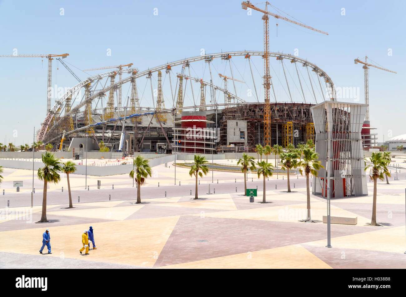 Workers walking past the work of the renovation (roof and cooling) of ...