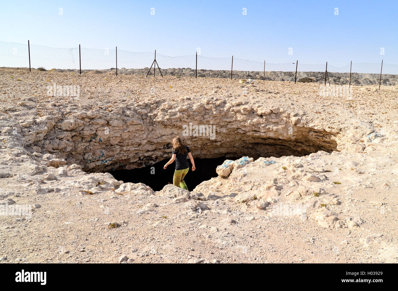 Girl entering Musfur sinkhole in Qatar, near Doha Stock Photo - Alamy